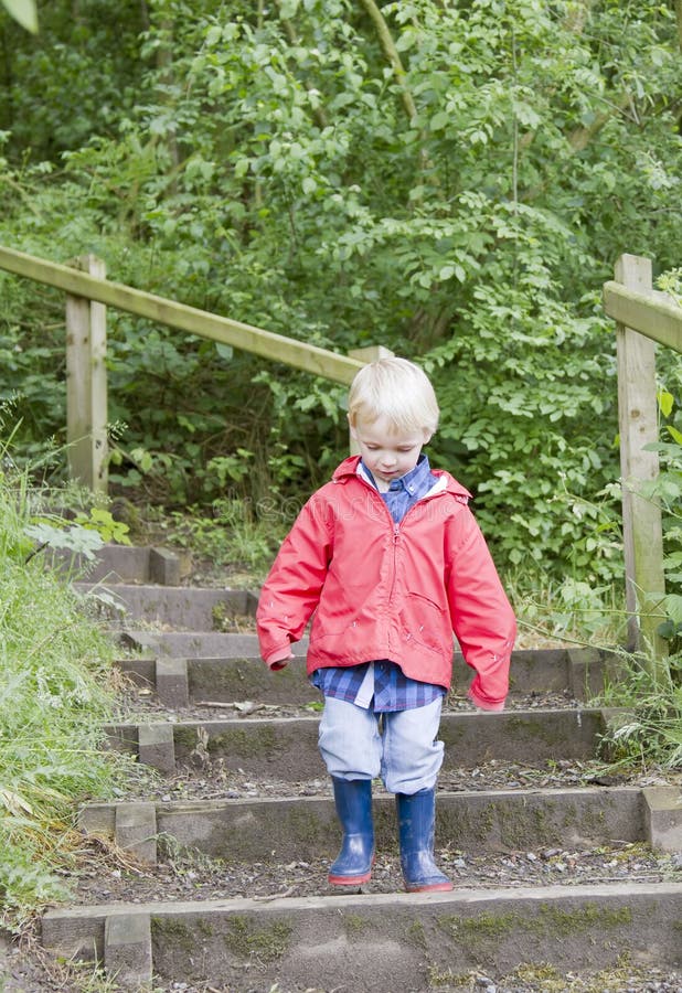 Blond Young Boy Walking Down Steps Stock Image - Image of happiness ...