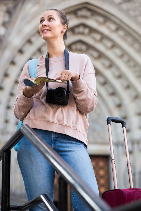 Blond Young Girl is Leafing through the Booklet Stock Photo - Image of ...
