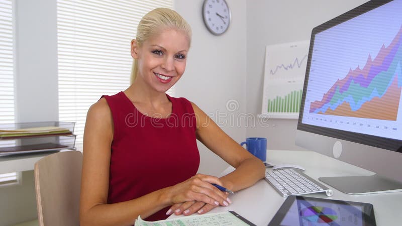 Blonde Business Woman Smiling while Sitting in Front of Computer Stock ...