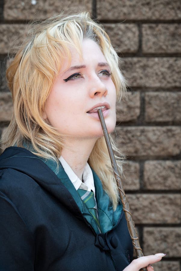 Blonde Caucasian Female Cosplayer Dressed As a Wizard with a Magic Wand ...