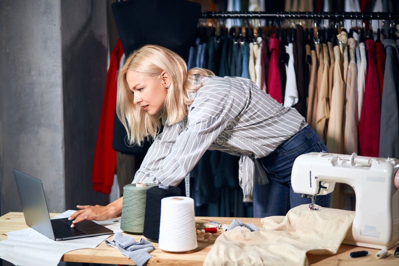 Blonde Designer Looking for New Models while Working in the Studio ...