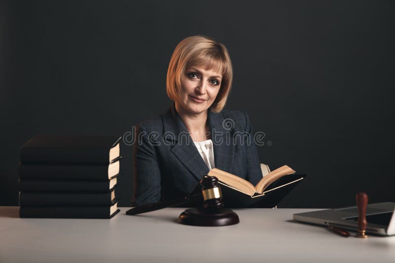 Blonde Female Advocate at the Workplace in Studio Reading Book. Stock ...