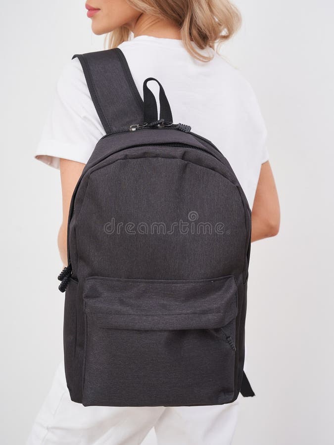 Stylish Blonde Model Poses with a Sleek Black Backpack in a Minimalist ...