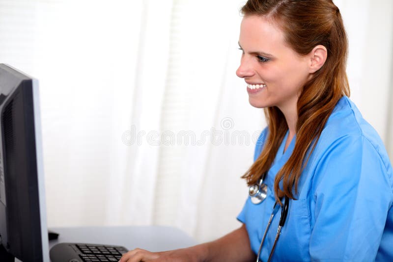 Blonde Friendly Nurse Looking To Computer Stock Photo - Image of ...