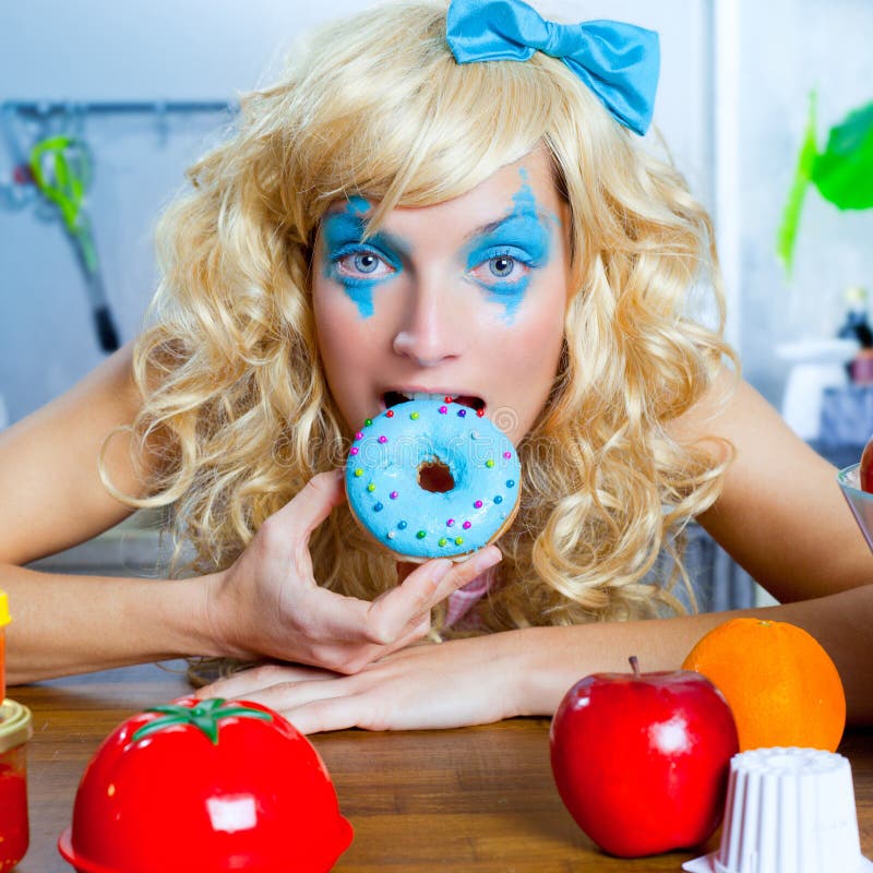Blonde Funny Girl on Kitchen Eating Blue Dona Stock Image - Image of ...