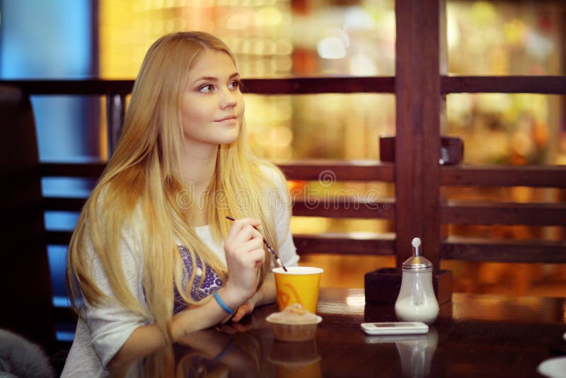 Blonde girl in a cafe stock photo. Image of beautiful - 64154406