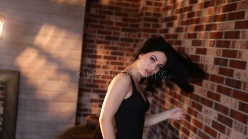 Blonde Girl In Evening Dress With A Neckline Near Brick Wall Slow