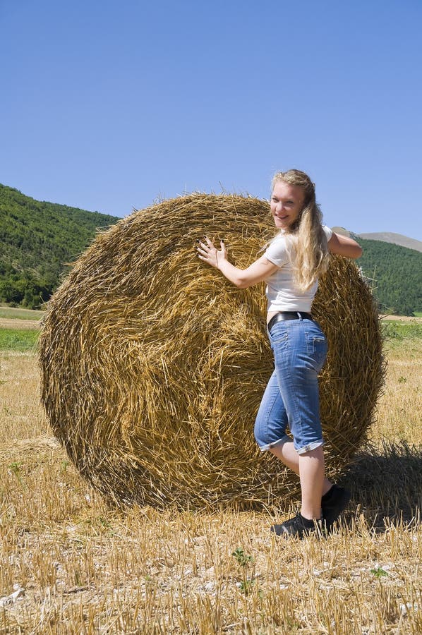 Country Girl Smiling At Haystack Stock Image - Image of brown, curly ...