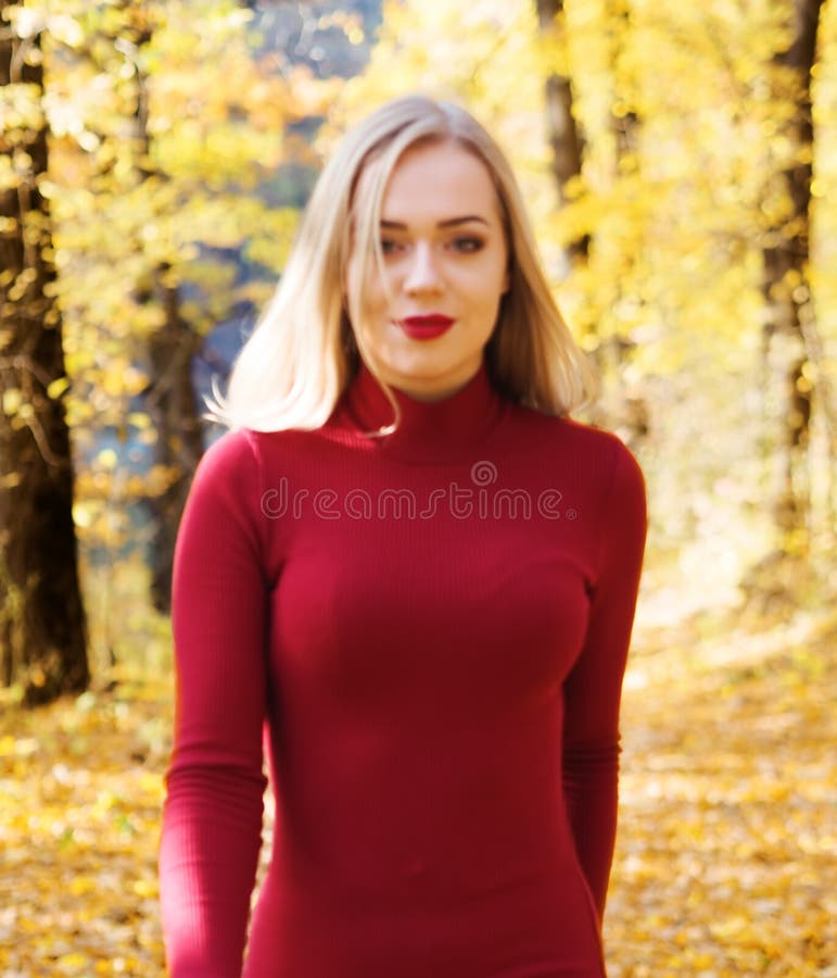 Blonde Girl Portrait At The Autumn Forest Back View At Falling Leaves