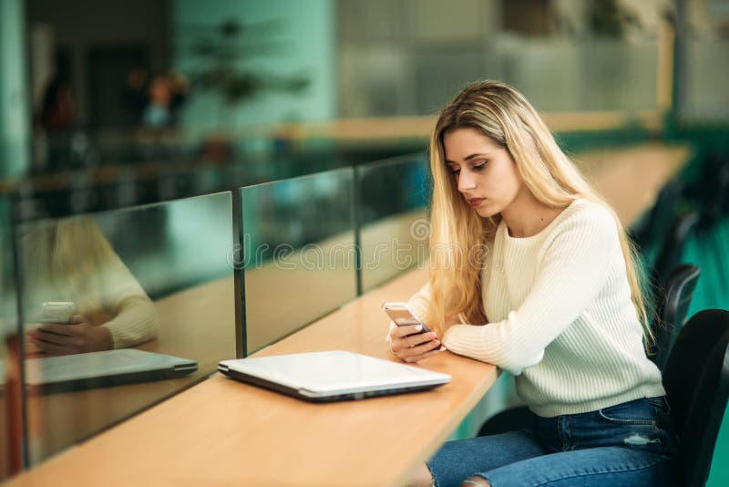Blonde Girl Use Phone in Library Stock Photo - Image of caucasian, girl ...