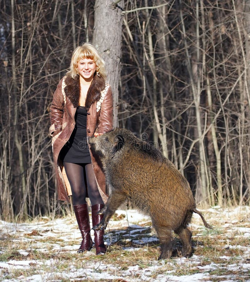 Blonde girl with wild boar stock image. Image of body - 9702623