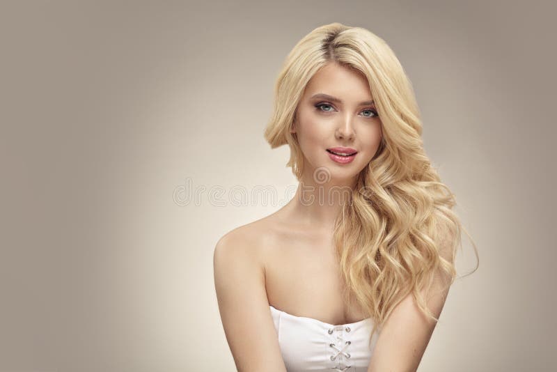 Sensual Young Lady With Healthy Wavy Long Blonde Hair Posing At