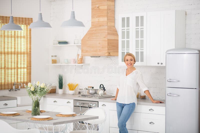 Blonde Housewife in Jeans Standing in the Kitchen Stock Image - Image ...