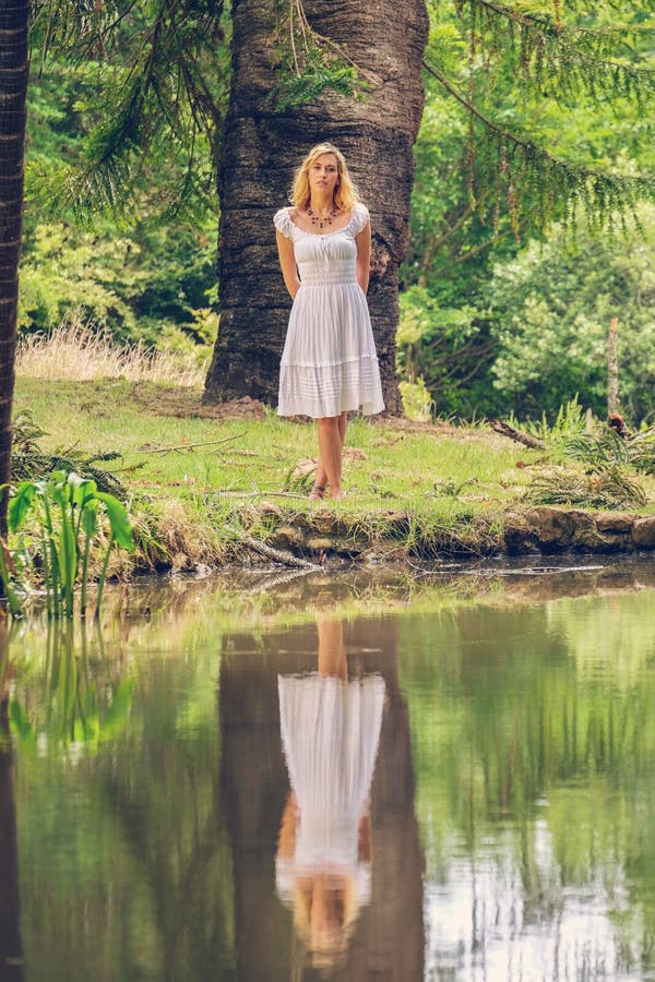 Blonde lady in the park stock photo. Image of woman, holding - 67207440