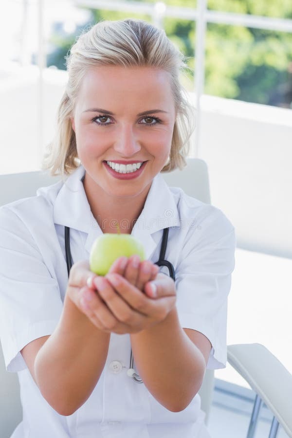 Blonde Nurse Holding a Green Apple Stock Image - Image of fair ...