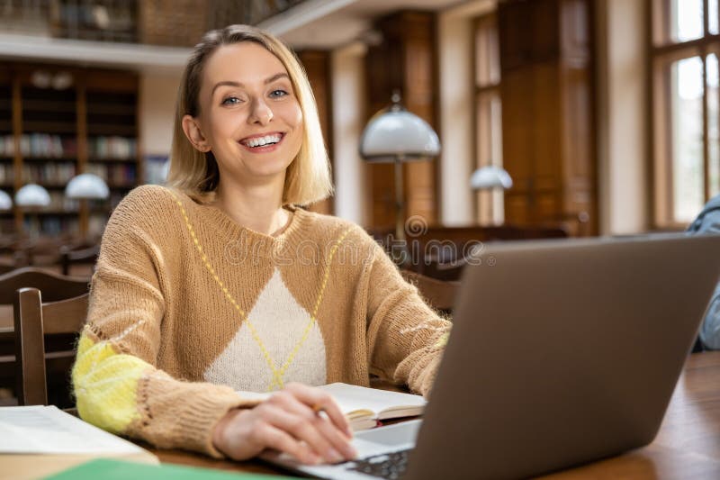 Blonde Smiling Woman at the Laptop in the Library Stock Photo - Image ...