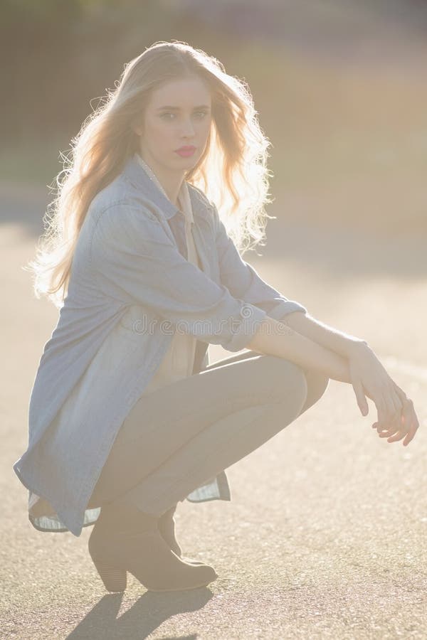 Blonde Woman Crouching Down On A Highway Stock Photo - Image of women ...