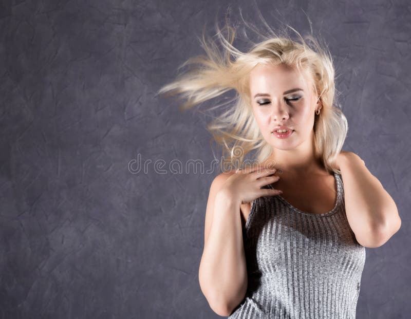 Blonde Woman With Hair In The Wind Girl With Flying Hair On A Gray