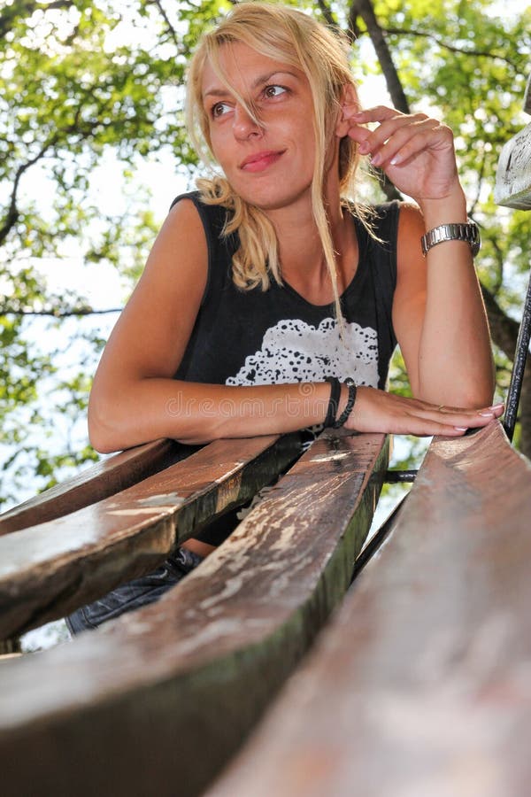 Blonde Woman Leaning on a Bench in the Park Stock Image - Image of ...
