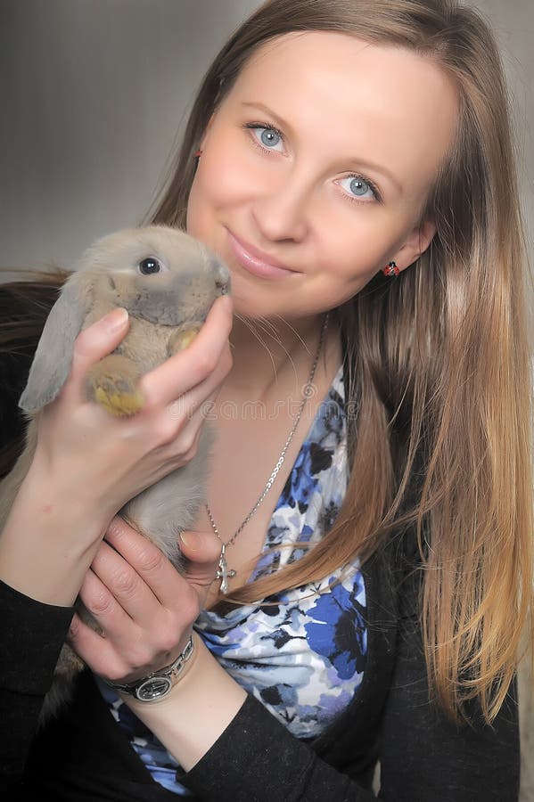 Blonde woman with a rabbit stock image. Image of funny - 40209787