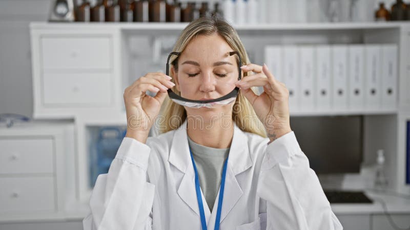 Blonde Woman Scientist Adjusting Goggles in a White Lab Stock Video ...