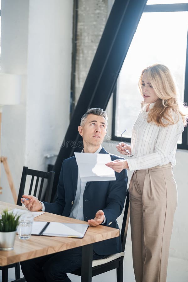 Blonde Woman Showing Na Document To Her Boss Stock Image - Image of ...