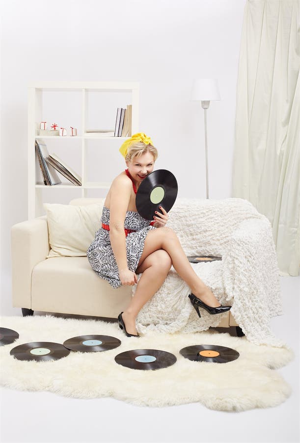 Blonde woman with vinyls stock image. Image of couch - 28579419