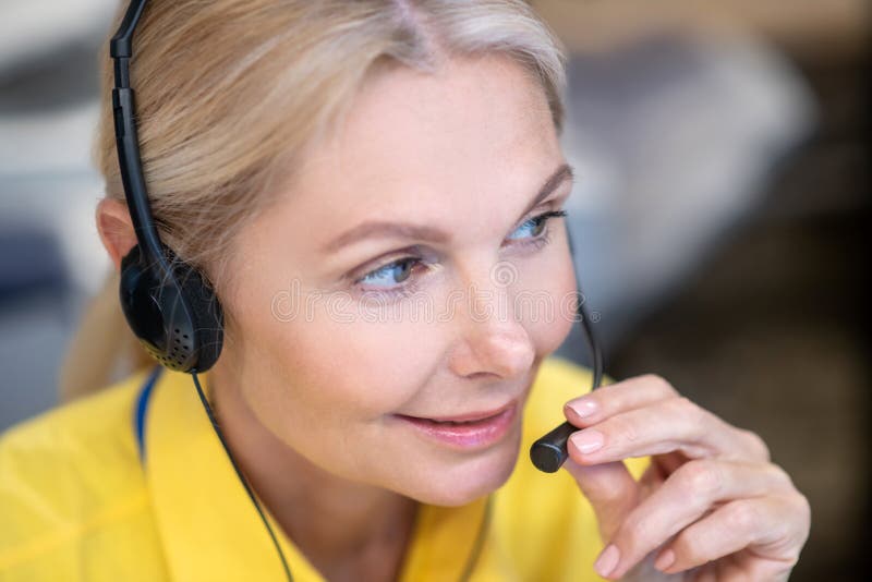 Blonde Woman Wearing Headphones, Speaking into Microphone Stock Photo ...