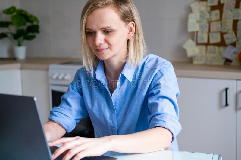 Blonde Woman is Working Office Work Remotely from Home on Kitchen ...