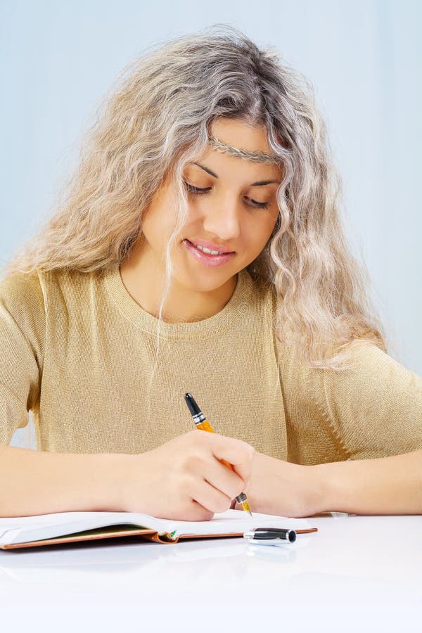 A Blonde Writing in Notepad Stock Image - Image of hair, looking: 31496233