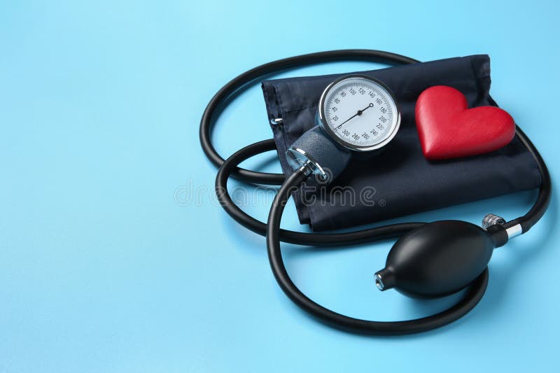 Blood Pressure Measuring Device and Heart Figure on Light Blue ...