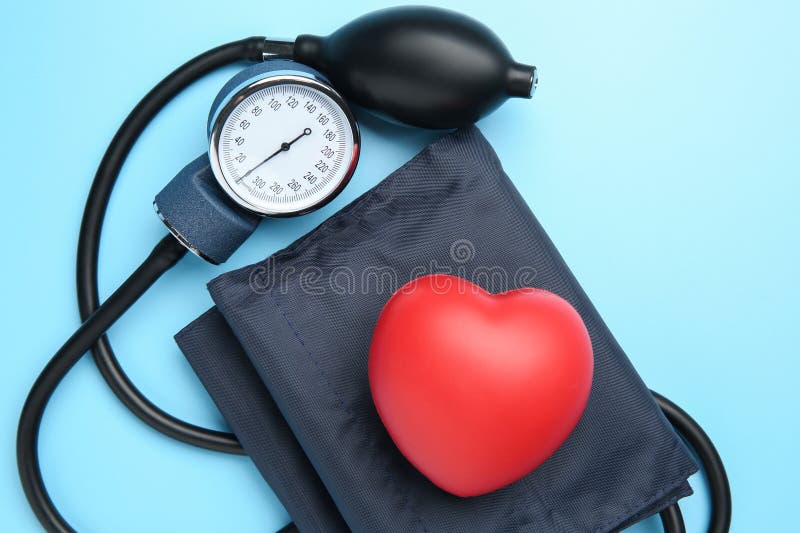 Blood Pressure Measuring Device and Squeeze Heart on Light Blue ...