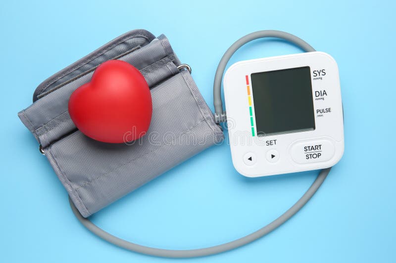 Blood Pressure Measuring Device and Squeeze Heart on Light Blue ...