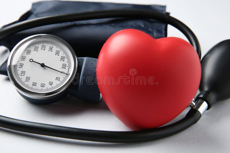 Blood Pressure Measuring Device and Squeeze Heart on Light Grey ...