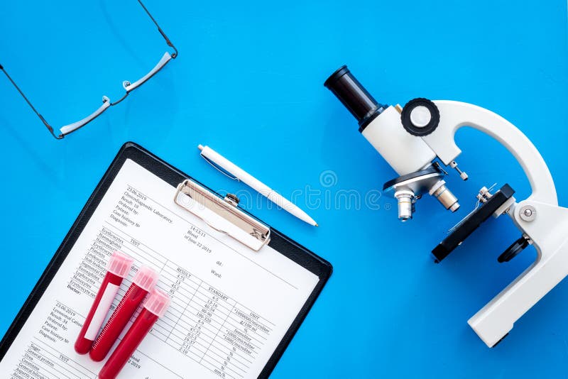 Blood Test Results Near Microscope on Blue Background Top View Stock ...