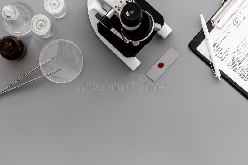 Blood Testing with Microscope in Laboratory. Equipment on Grey ...