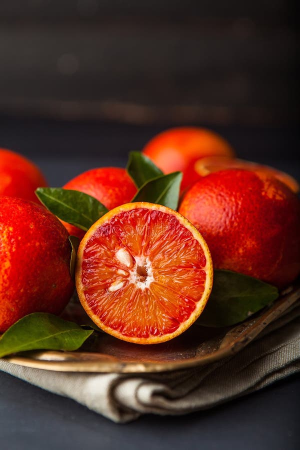 Bloody Red Oranges Slices with Leaves on Wooden Background Stock Image ...