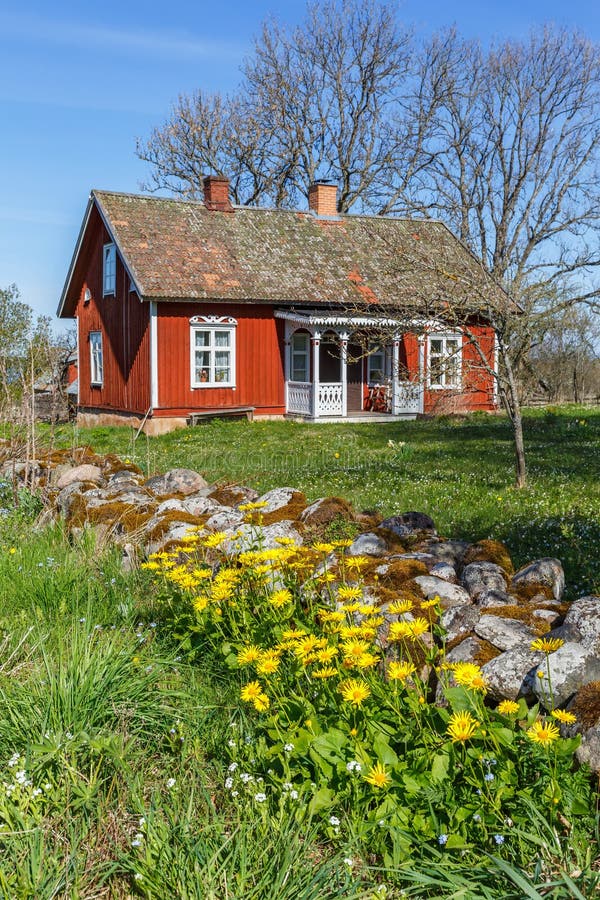 Blooming Spring Flowers in a Garden with a Red Cottage Stock Image ...