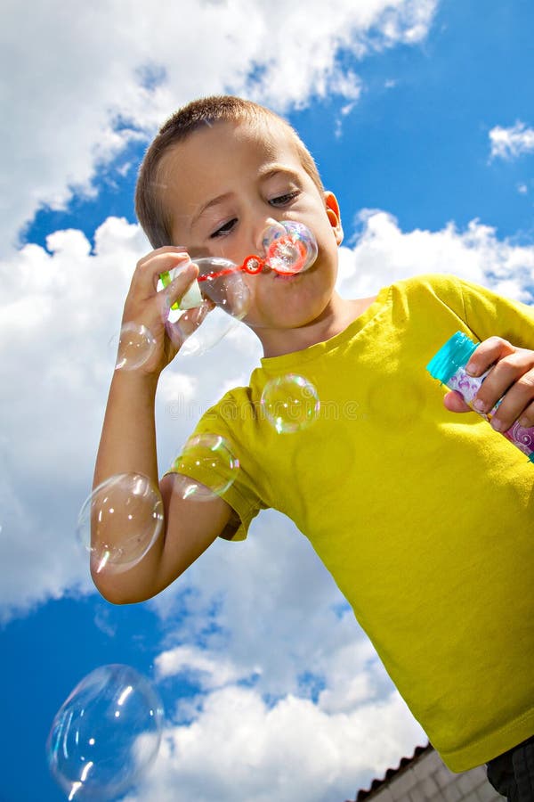Children blowing bubbles stock photo. Image of kids, brother - 2427876