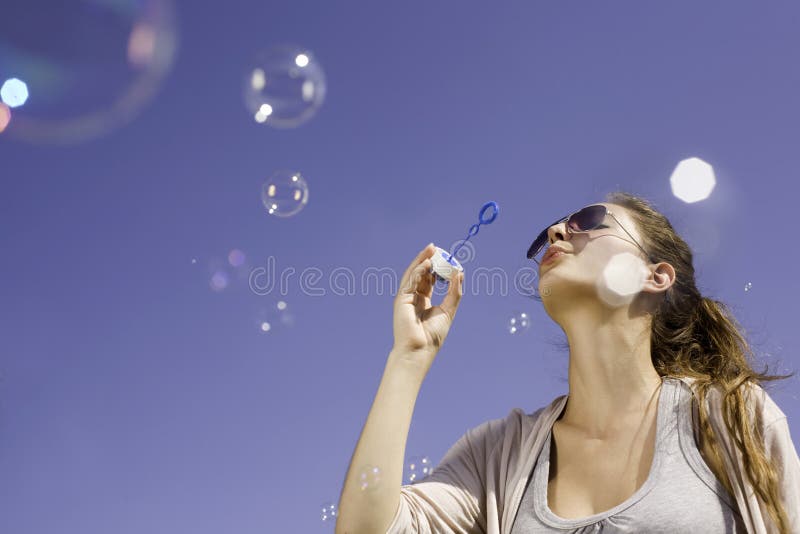 Blowing Bubbles into the Wind. Stock Photo - Image of profile, happy ...