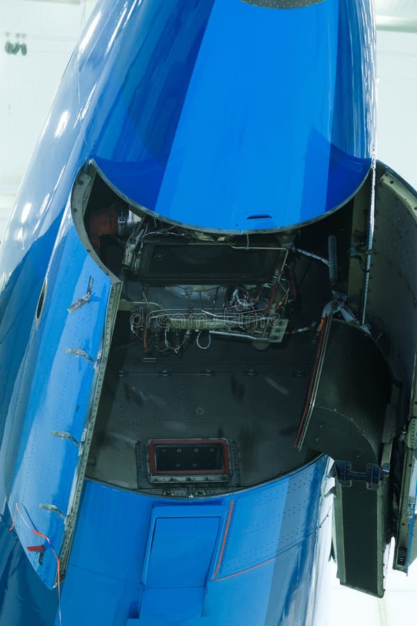Blue Airplane Fuselage Showing Open Maintenance Hatch Revealing Technical Components and Wiring ...