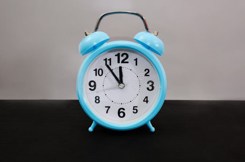 Blue Alarm Clock on a Black Table. almost Midnight on the Alarm Clock ...