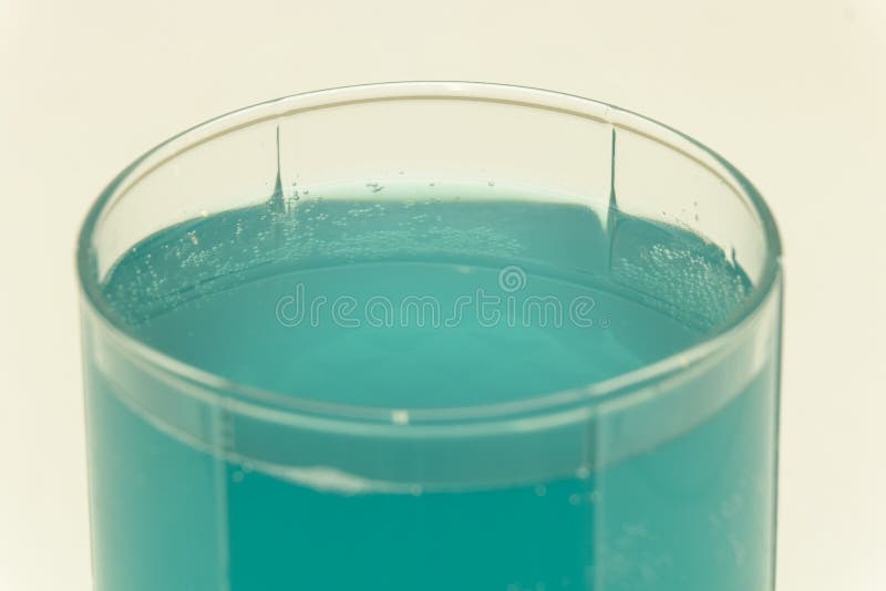 Blue Ale with Bubbles and Ice. Pouring the Drink in the Glass. Bright ...