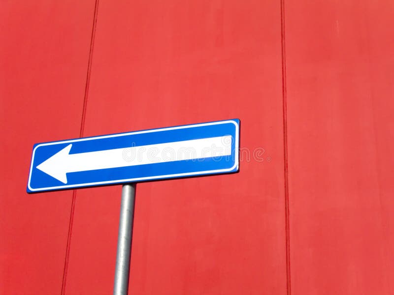 Blue arrow sign on red stock image. Image of point, points - 927083