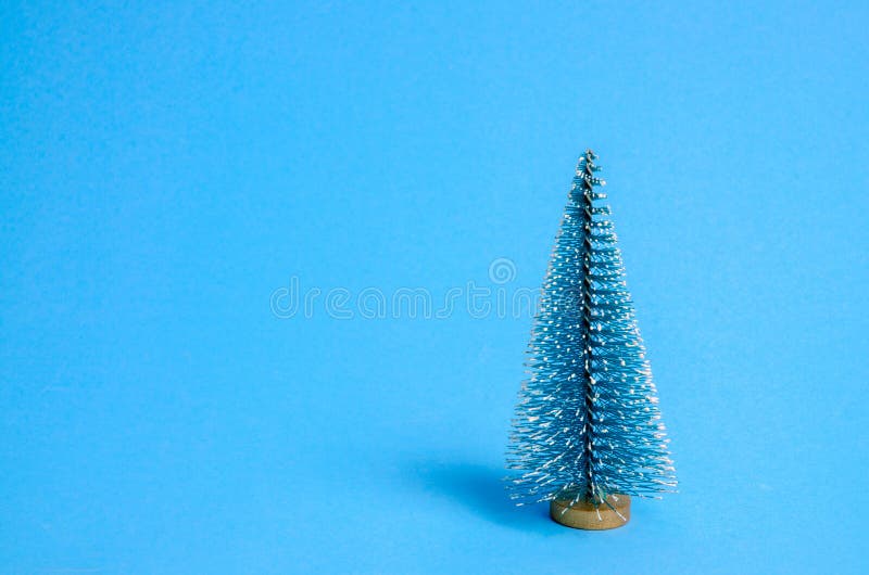 Blue Artificial Christmas Tree with on Blue Background with Copy Space ...