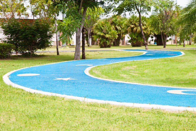 Blue Asphalt Path Via Green Grass Stock Image - Image of detail, rock ...