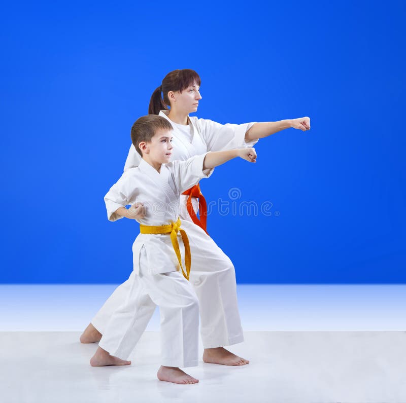 On a Blue Background Mother and Son are Hitting a Punch Arm Stock Photo ...