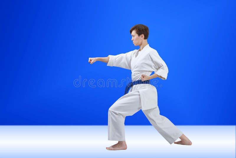 On a Blue Background Sportswoman is Beating Punch Arm Stock Photo ...