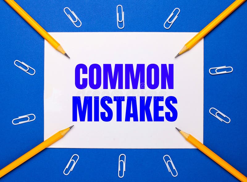 On a Blue Background, White Paper Clips, Yellow Pencils and a White ...