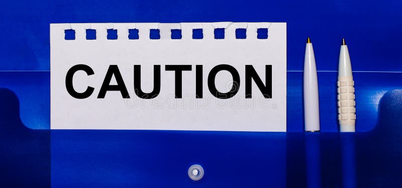 On a Blue Background, White Pens and a Sheet of Paper with the Text ...